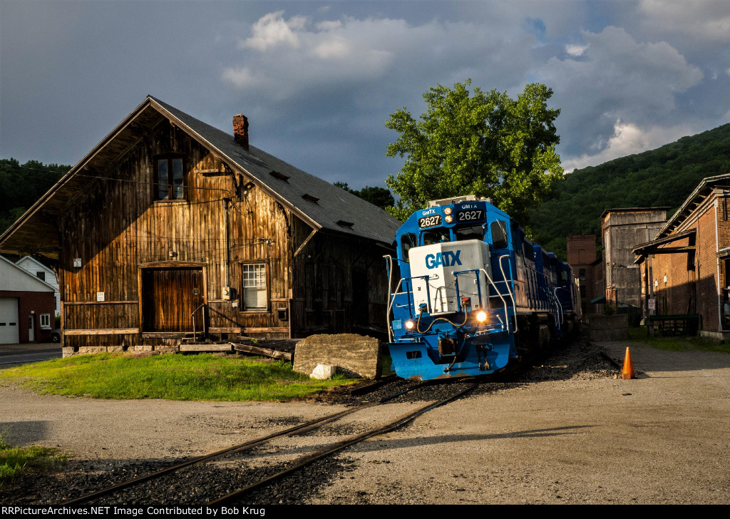 GMTX 2627 leads train NX-12 past the ex-New Haven freight depot in Housatonic
